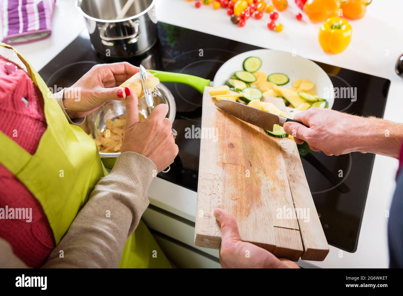 Young couple cooking together in hi-res stock photography and images ...