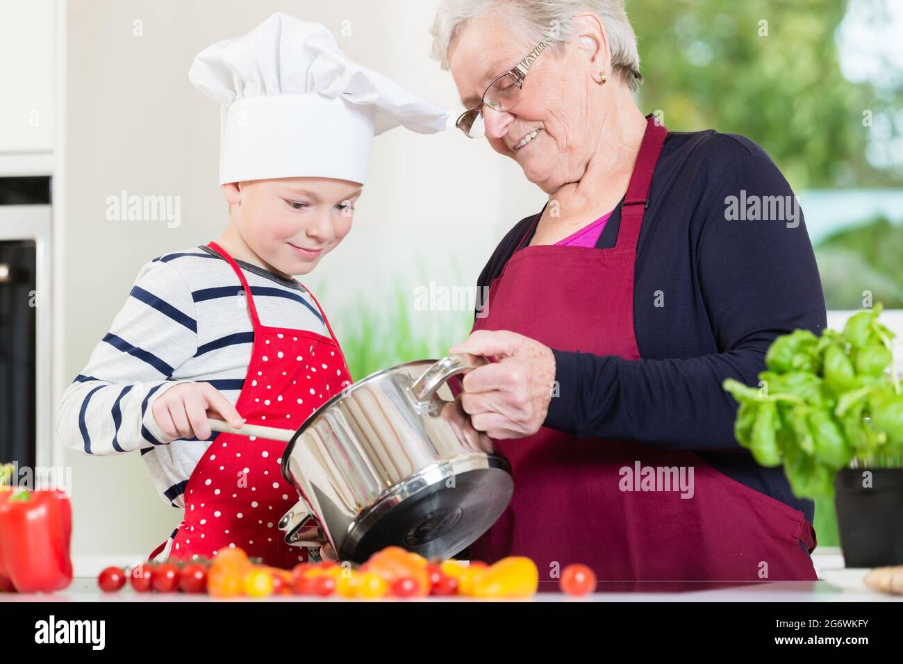 Happy granny cooking together with her grandson Stock Photo - Alamy