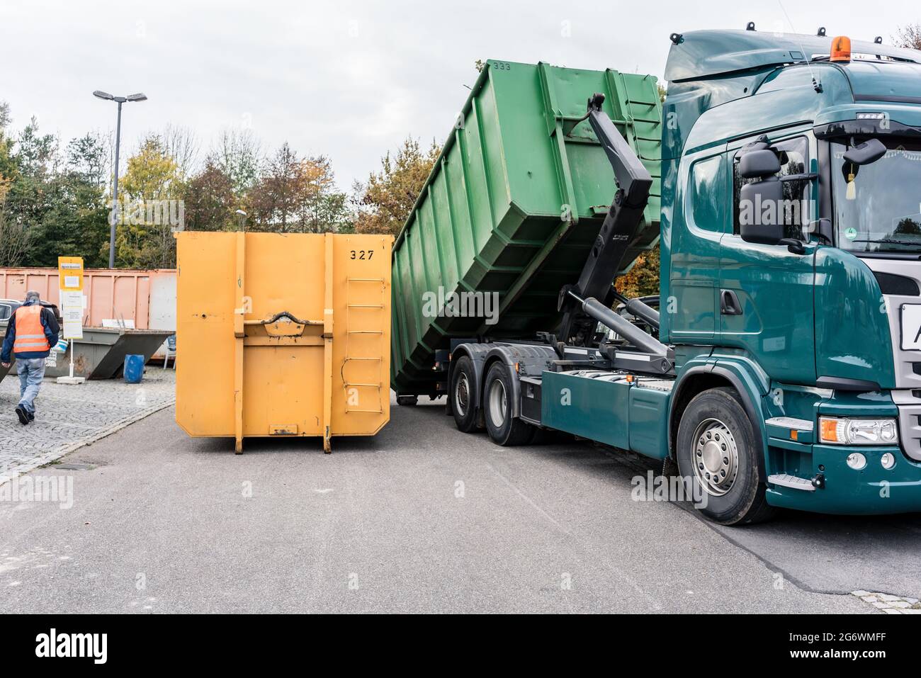 Truck loading container with waste in recycling center to transport ...