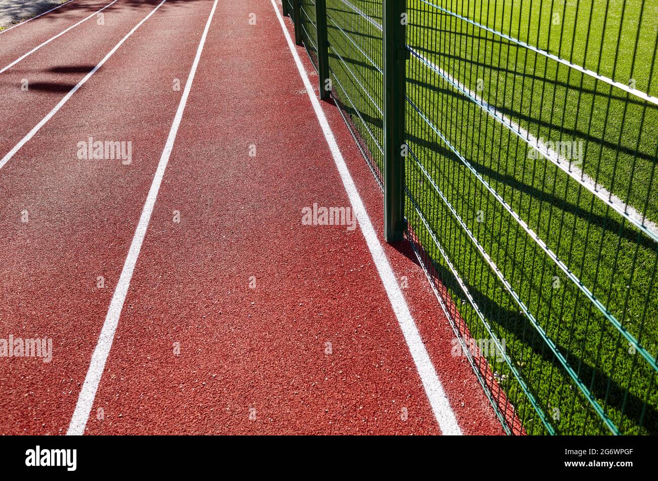 Red treadmill on sport field. Running track on the stadium Stock Photo ...