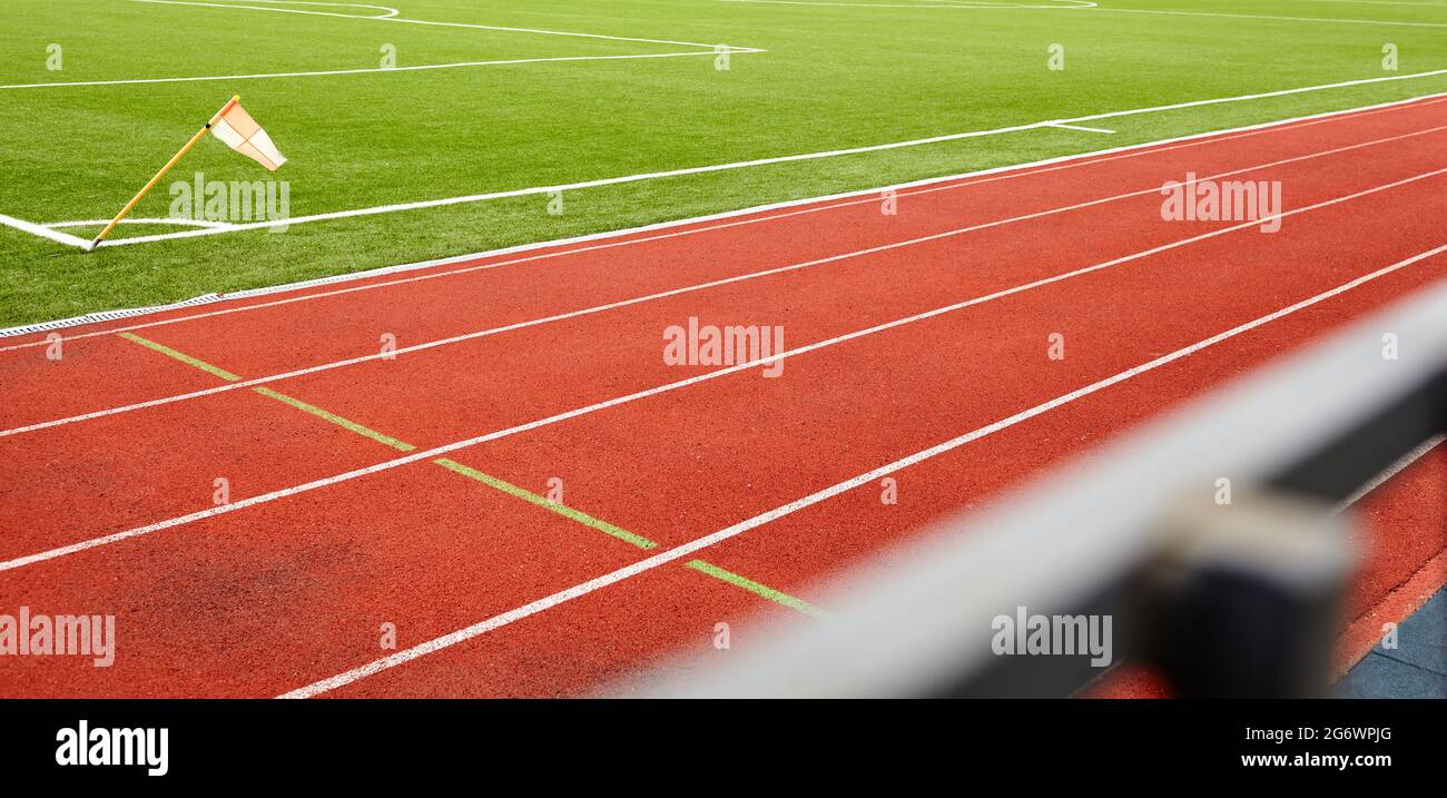 Red treadmill on sport field. Landscape of soccer field with green ...