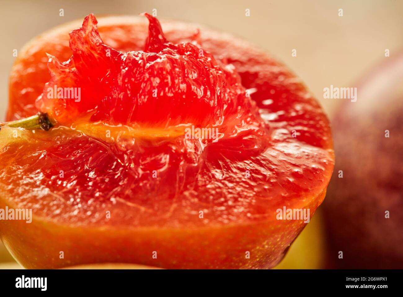 Fresh red plum, cut in half with pits, ready to eat Stock Photo - Alamy