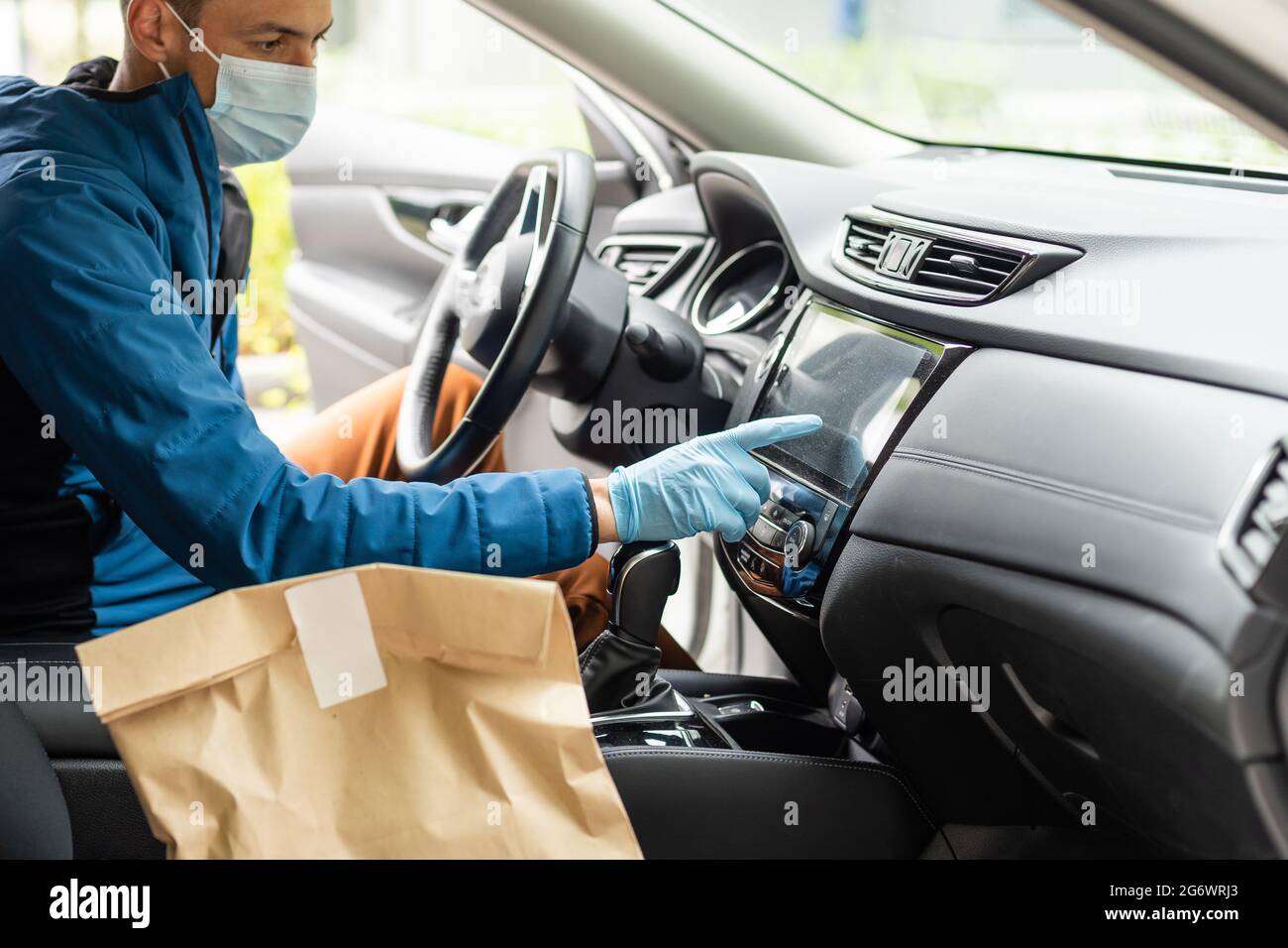 Delivery driver driving with parcels on seat Stock Photo - Alamy
