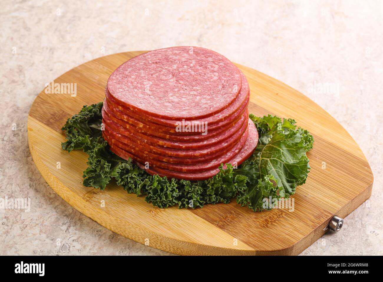 Sliced salami pork sausage snack over board Stock Photo - Alamy