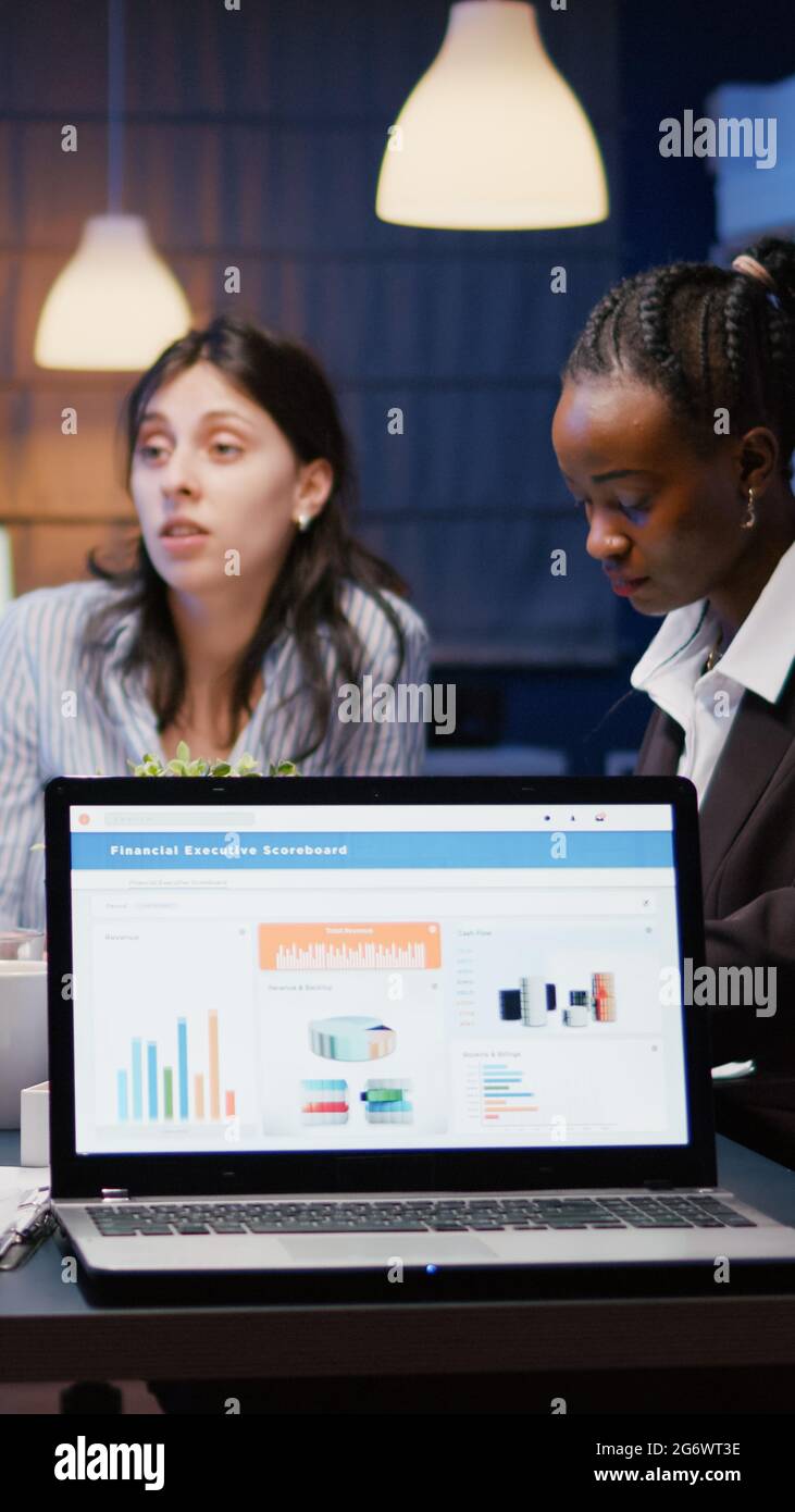 Laptop computer with financial graphs presentation on monitor standing ...