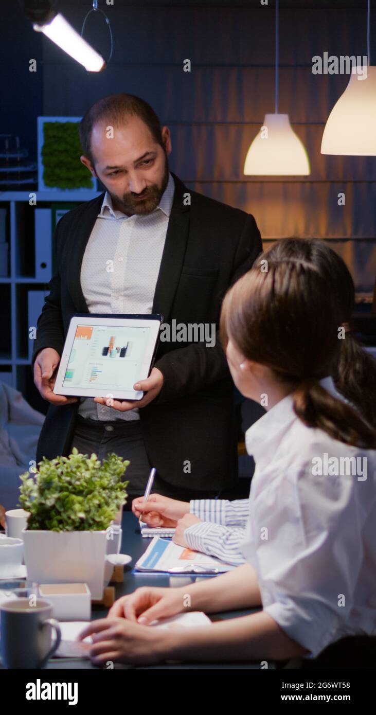 Overworked businessman showing financial graphs hi-res stock ...