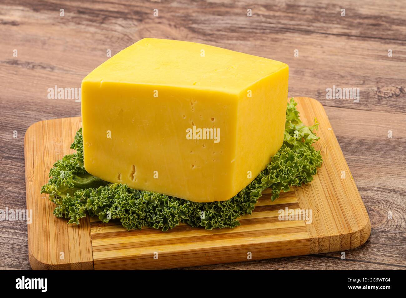 Yellow tilsiter cheese dairy product brick Stock Photo - Alamy