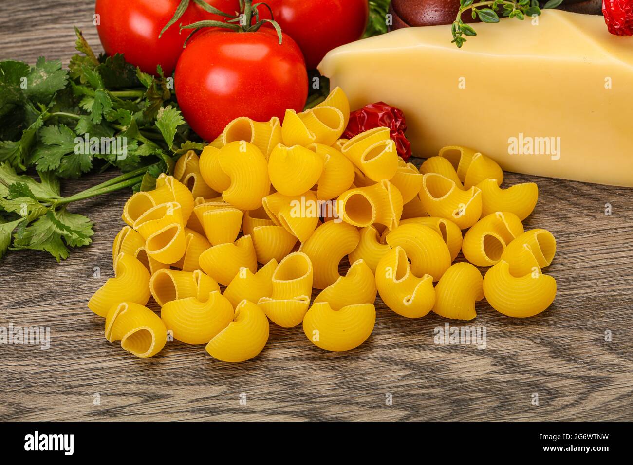 Italian pasta - raw pipe rigate served vegetables Stock Photo - Alamy