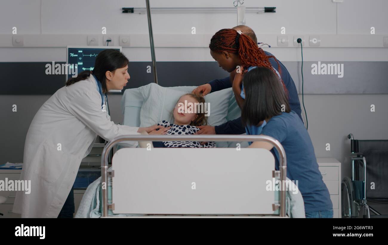 Hospitalized sick child suffering pain attack while medical team ...