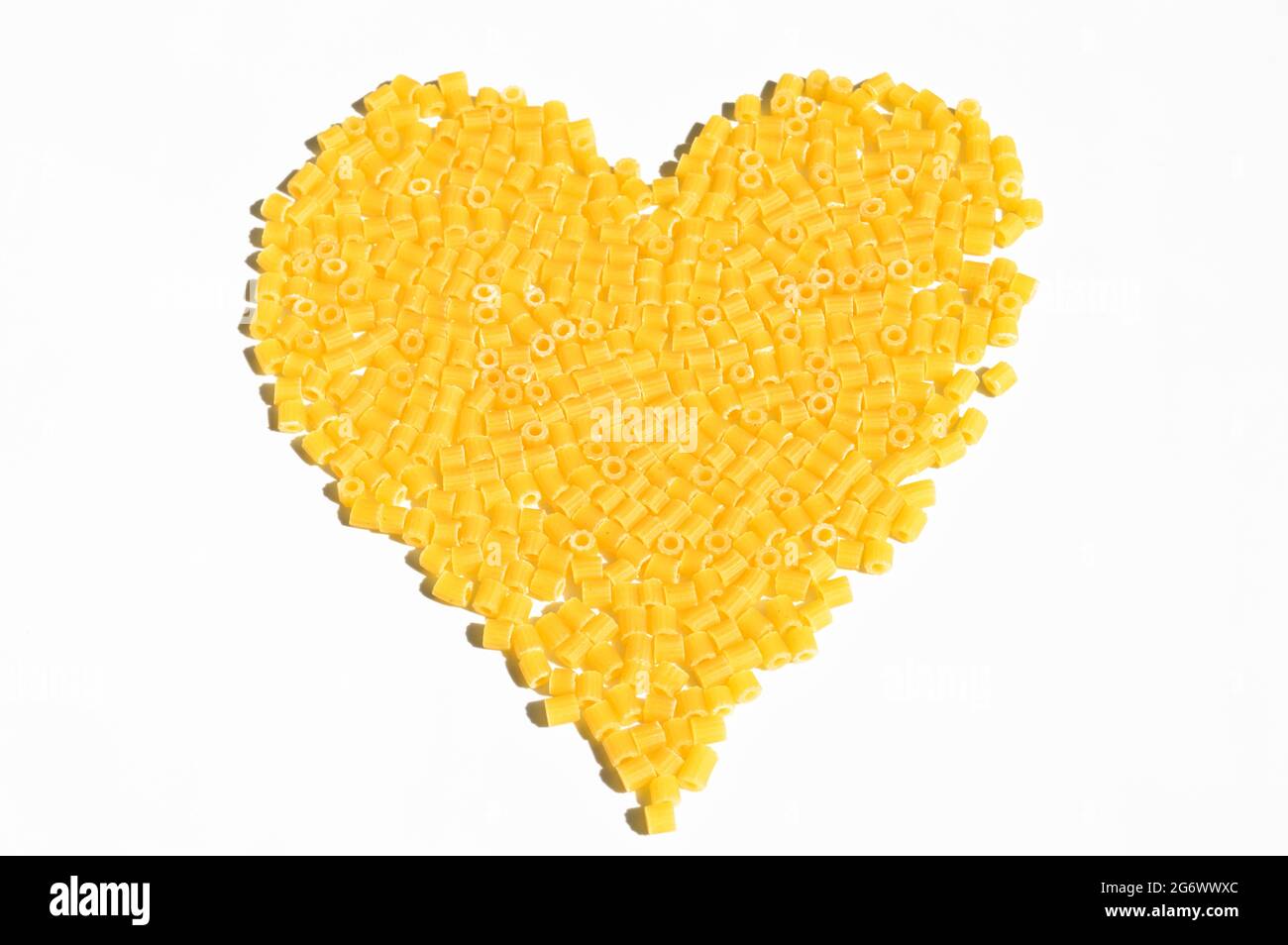 Heart shaped, raw fresh and healthy dry macaroni pasta foot background ...