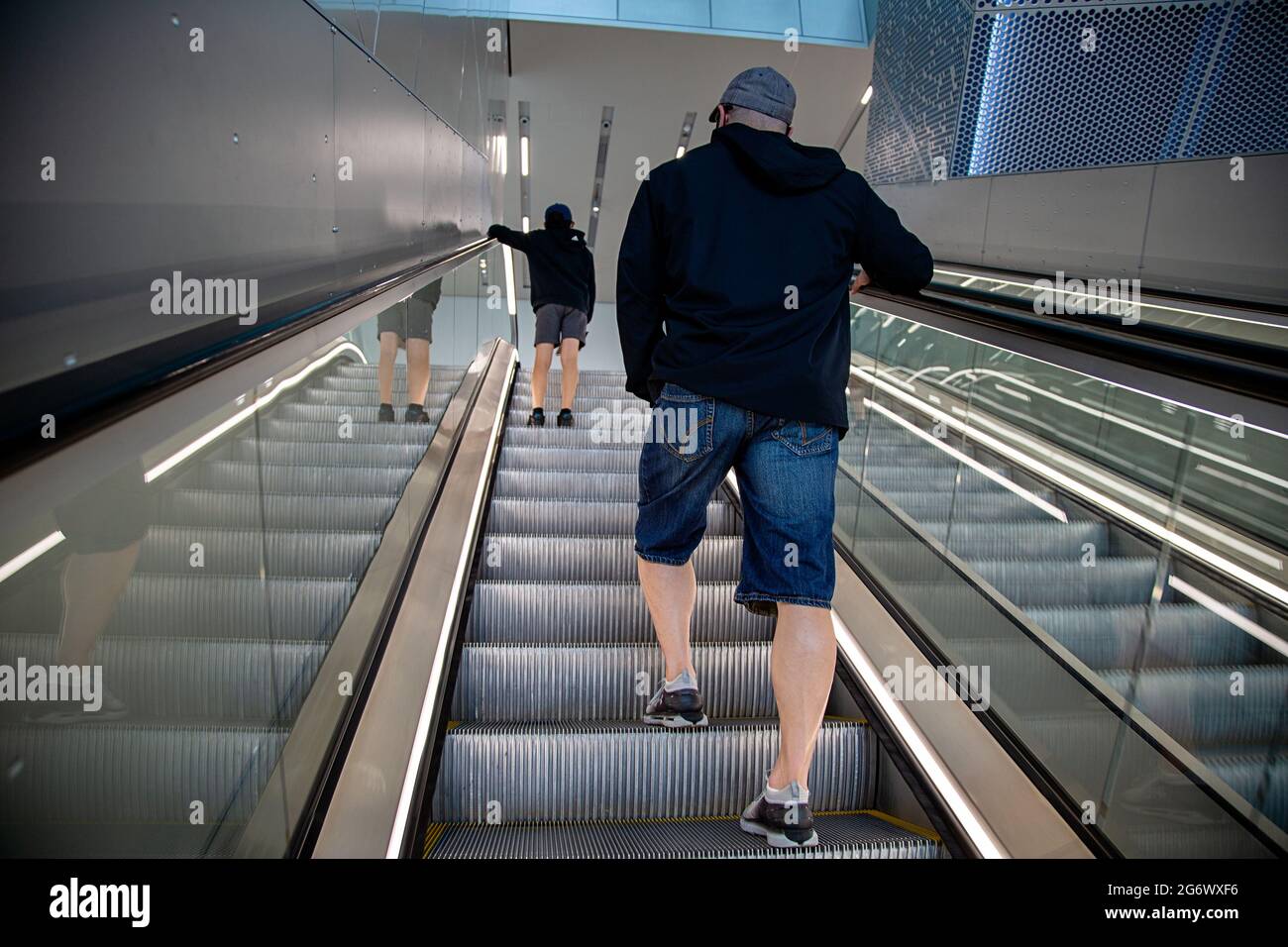 Child on escalator hi-res stock photography and images - Alamy