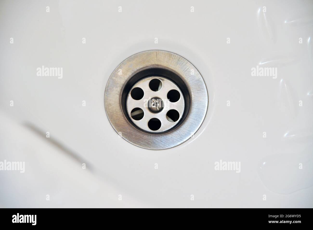 Drain in a white clean sink, background, close-up Stock Photo - Alamy