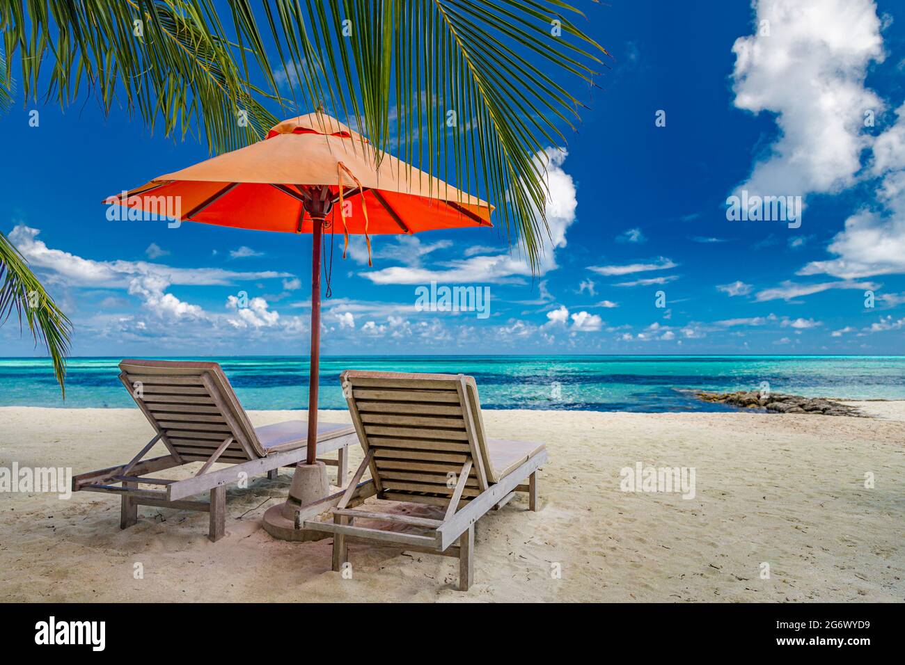 Beautiful tropical island scenery, two sun beds, loungers umbrella ...