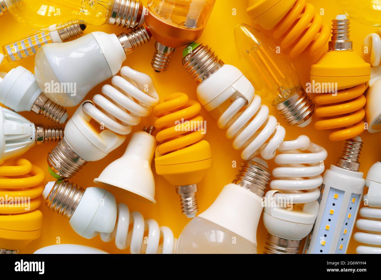 Light bulb on yellow paper background top view Stock Photo - Alamy