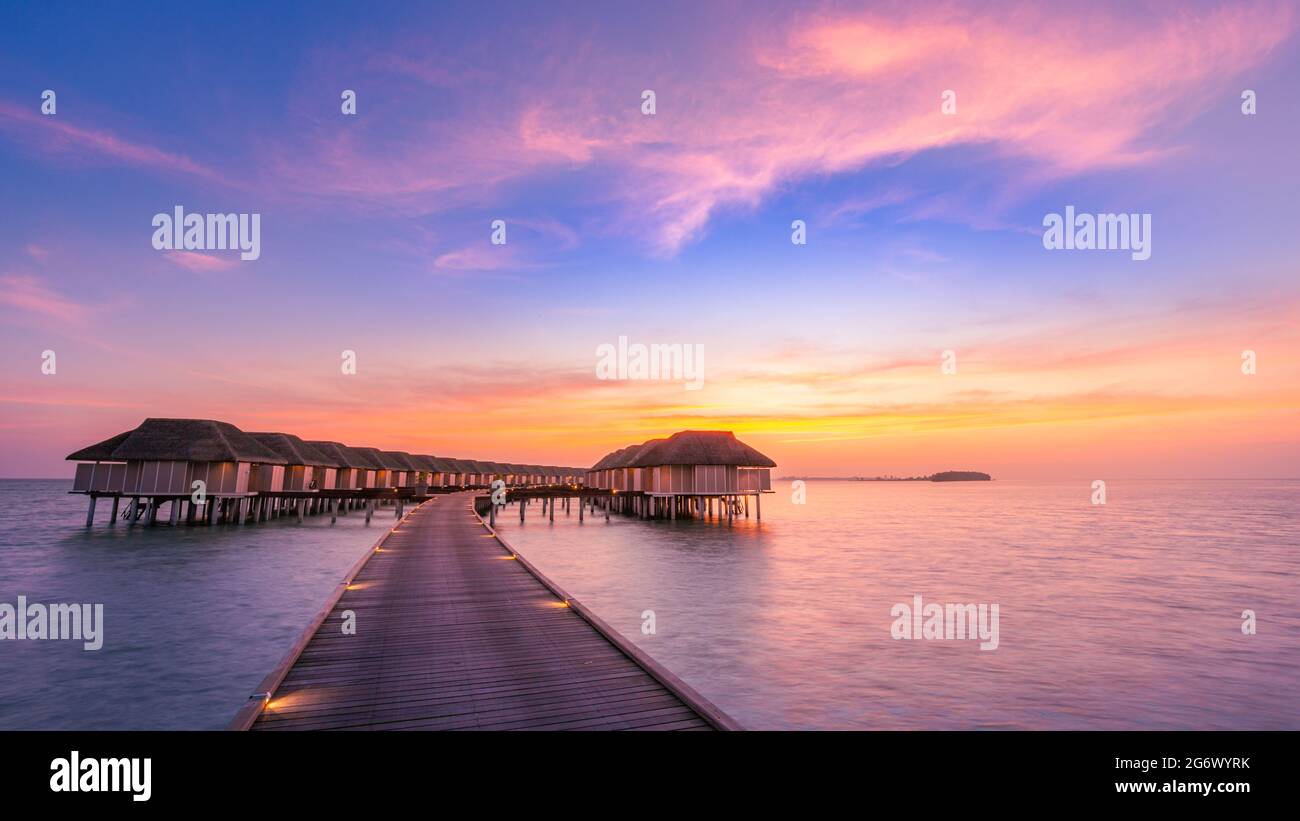 Panoramic sunset view Maldives island, luxury water villas resort and ...