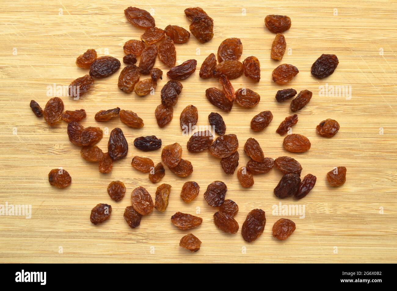 Organic and healthy raisin grains on bamboo cutting board Stock Photo ...
