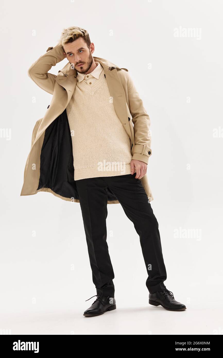 handsome man holding his hand behind his head posing coat autumn style ...