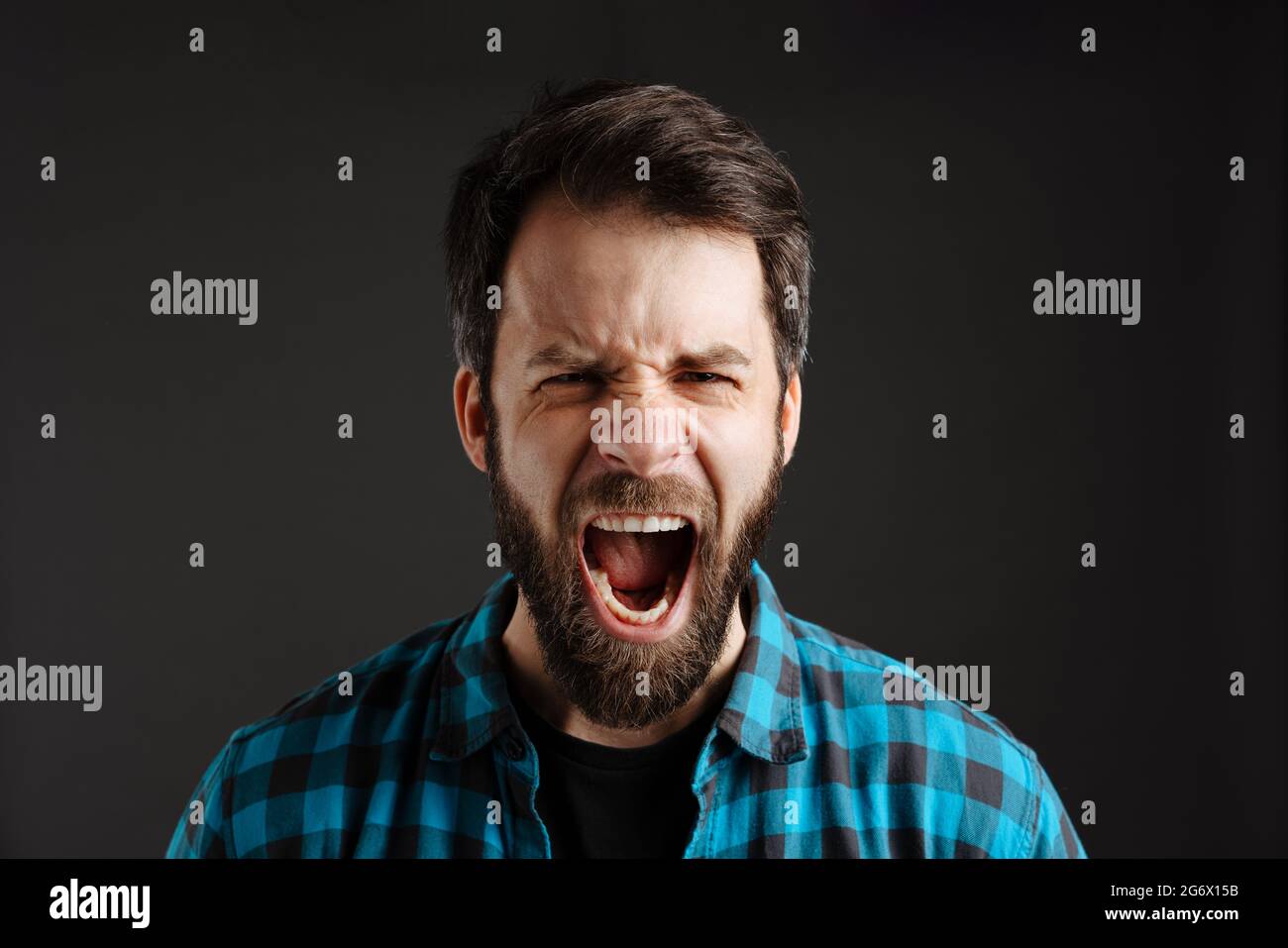 Bearded white angry man screaming and looking at camera isolated over ...