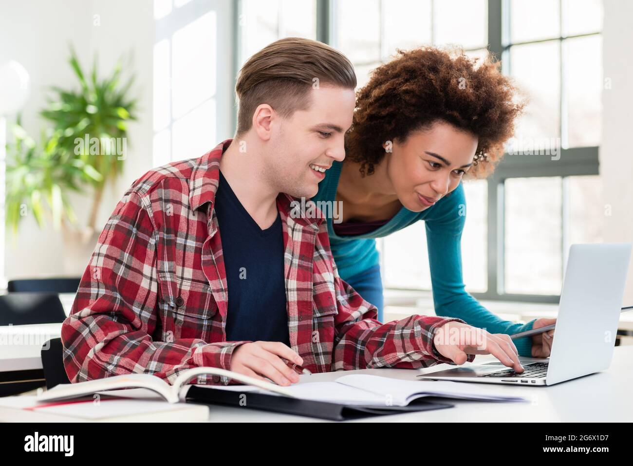 Ethnic college students writing hi-res stock photography and images - Alamy