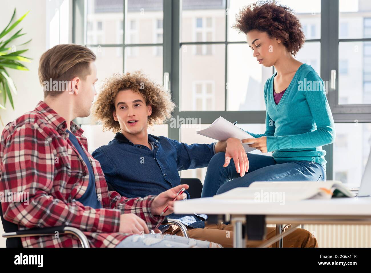 Young African American student writing ideas and observations during ...