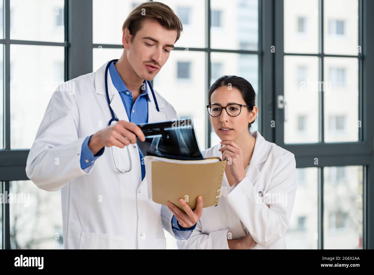 Experienced male physician and his female colleague interpreting the ...