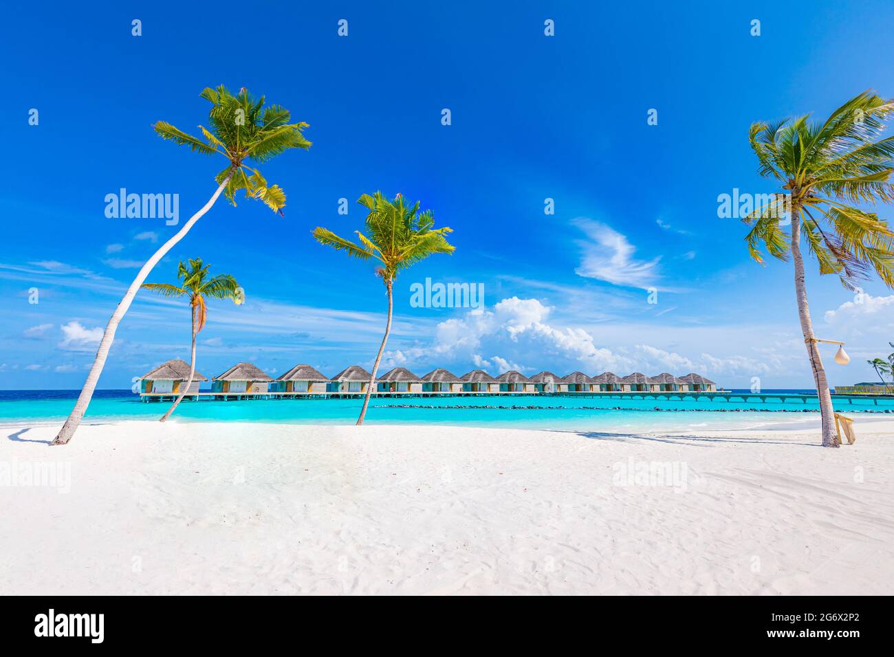 Idyllic tropical beach landscape with water villas and bungalows ...
