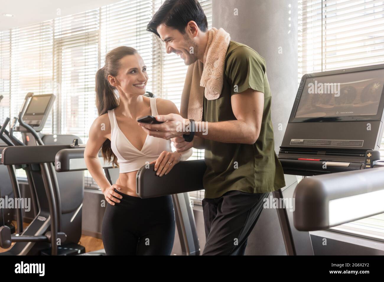 Young couple smiling while communicating on the mobile phone during ...