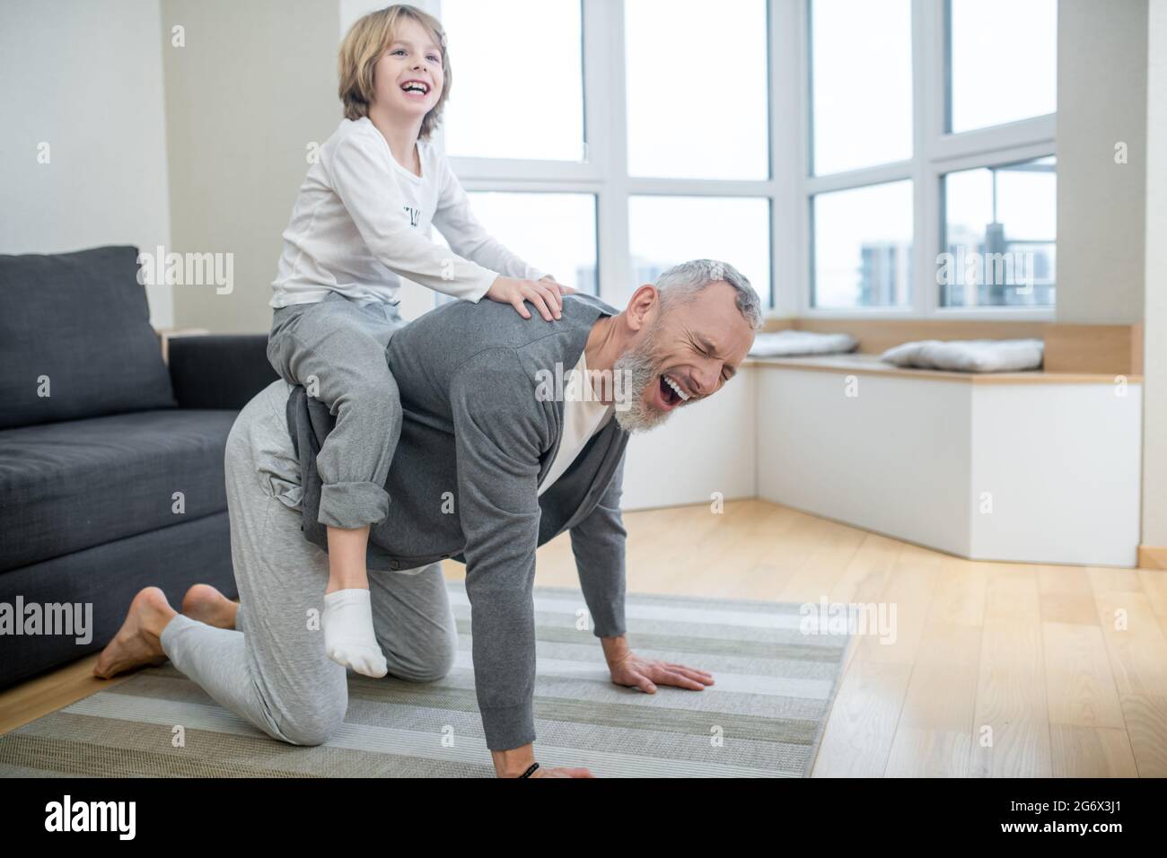 Dad and kids having fun at home and looking excited Stock Photo - Alamy