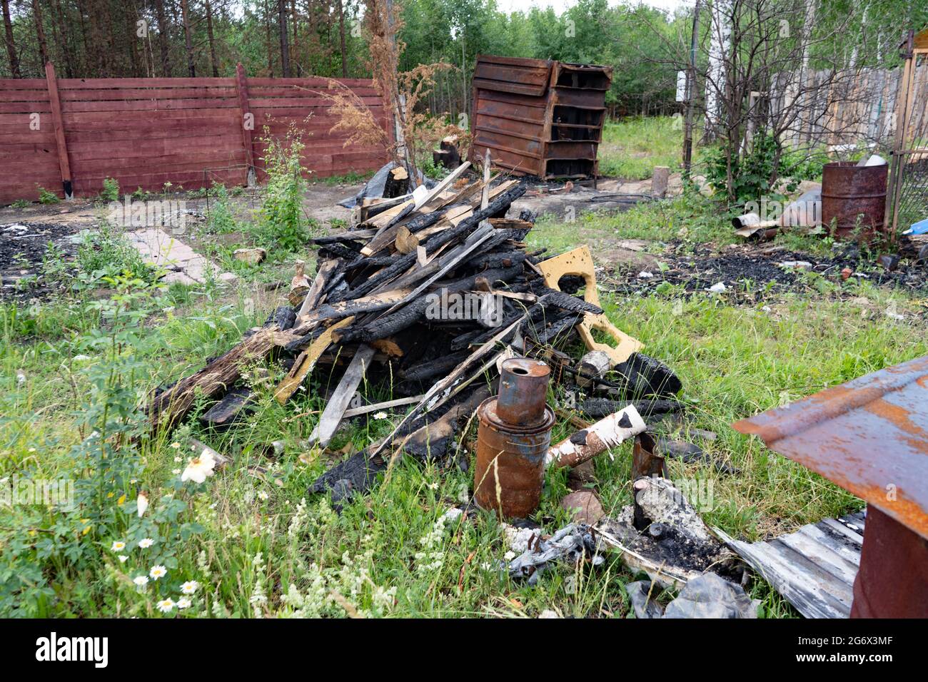 Garbage, boards, barrels after a fire on a pre-household plot. Disaster ...