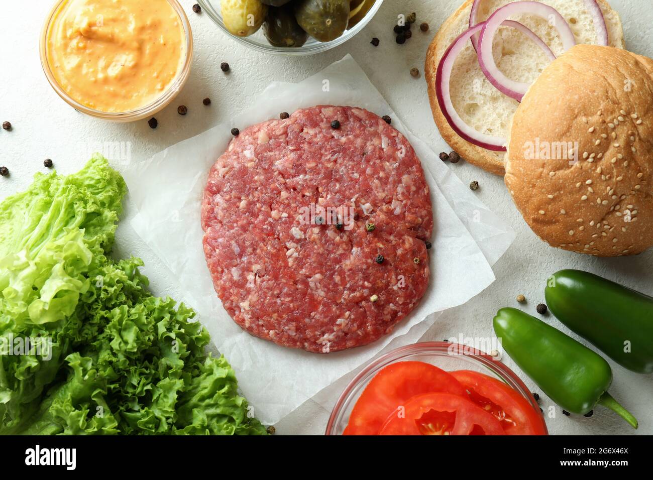 Concept of cooking burger on white textured background Stock Photo - Alamy