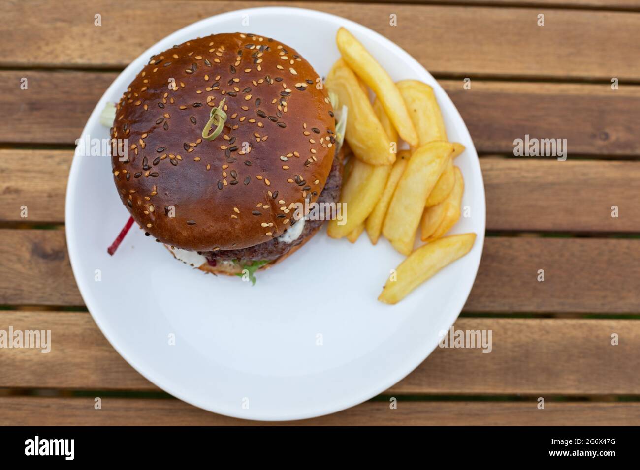 Homemade tasty cheeseburger being cooked on a on backyard barbecue ...