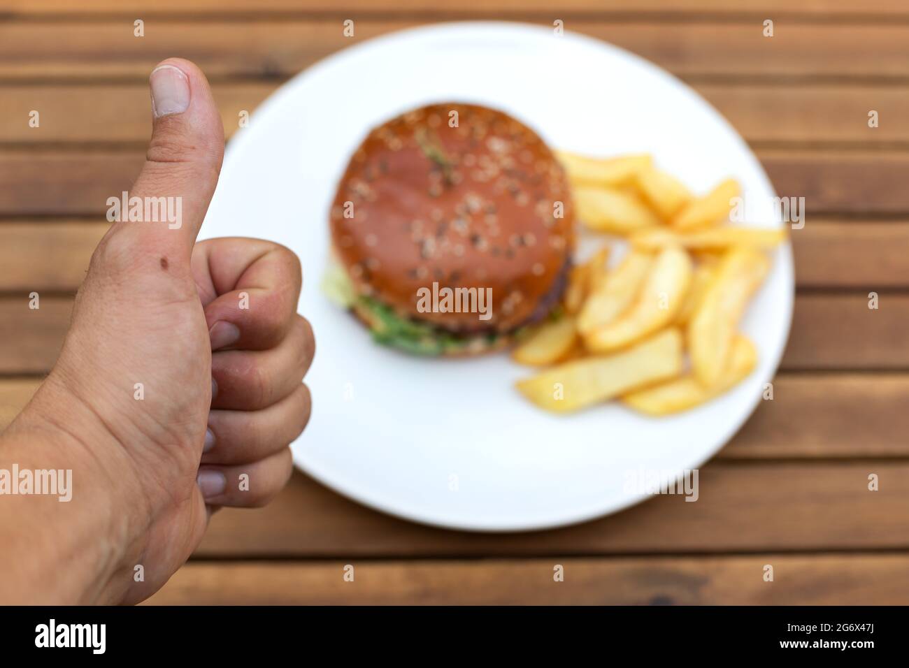 Homemade tasty cheeseburger being cooked on a on backyard barbecue ...