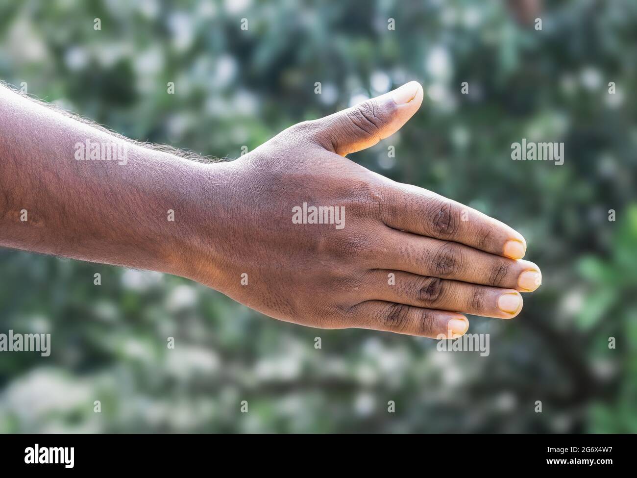 A black hand stretching toward to help or handshake Stock Photo - Alamy