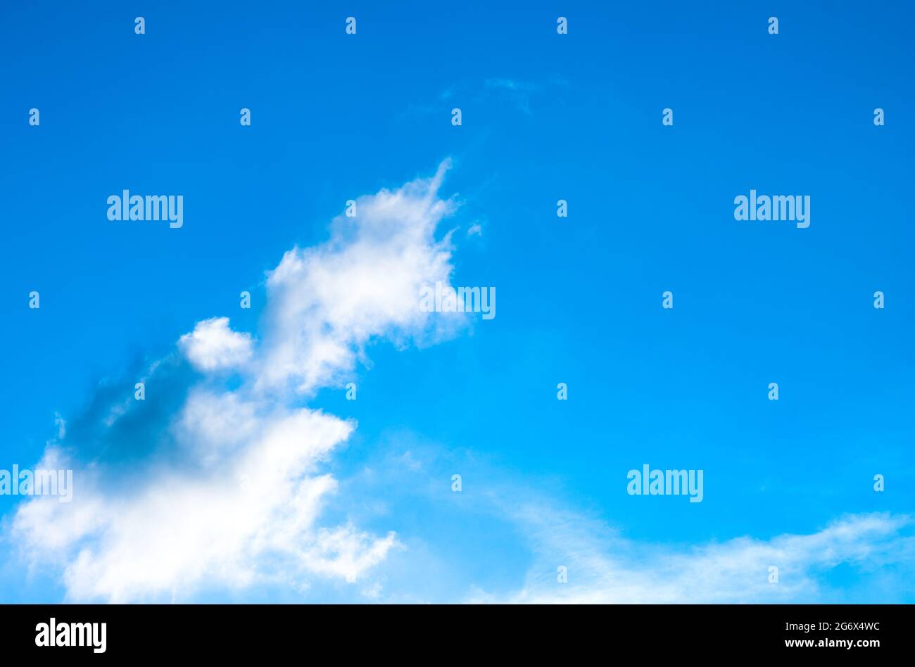 Clean blue sky with few white clouds Stock Photo - Alamy