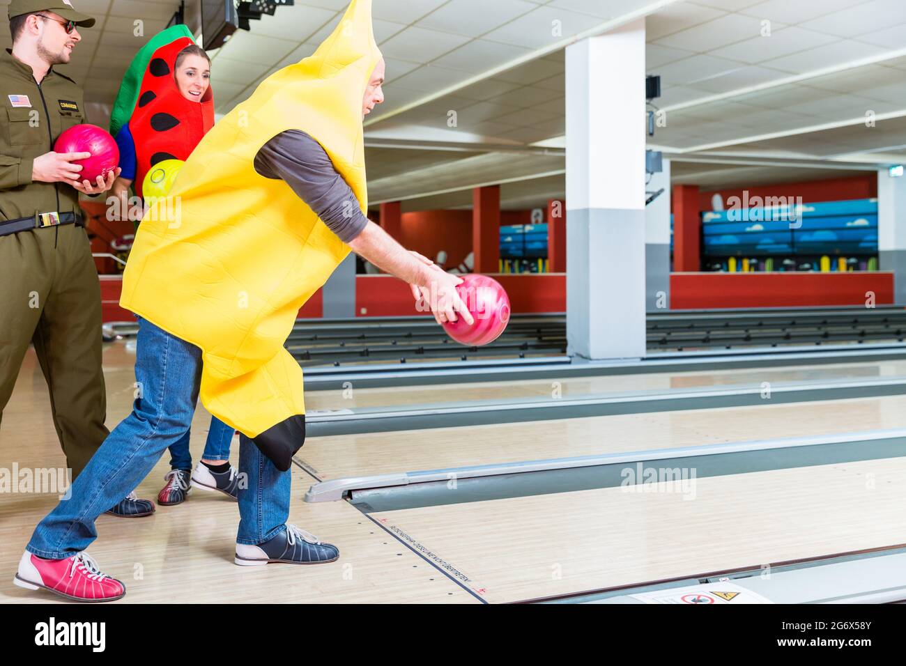 Side view of a mature man bowling Stock Photo - Alamy