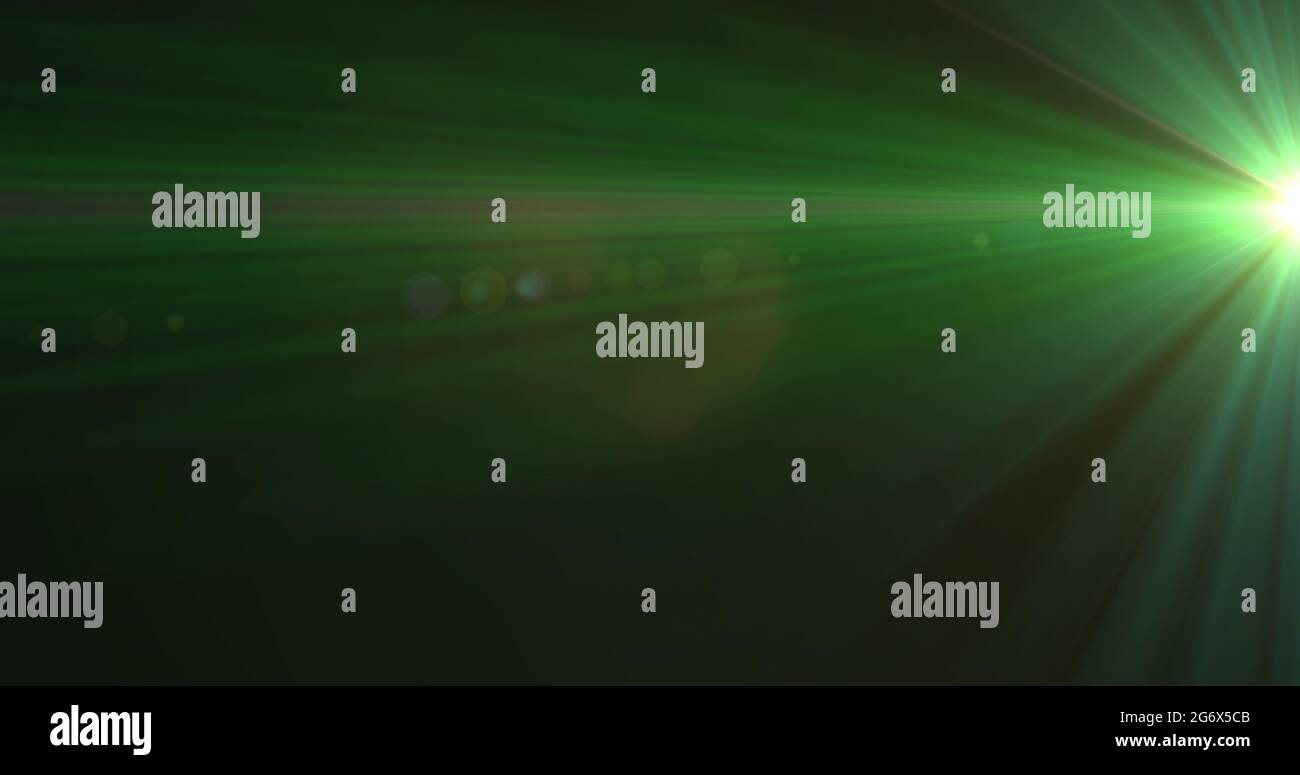 Glowing green rays of light moving against black background Stock Photo ...