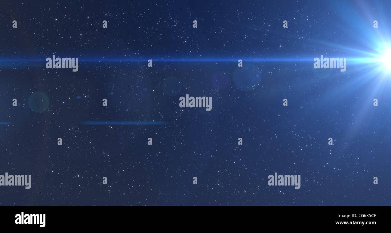 Glowing blue rays of light moving in the night sky Stock Photo - Alamy