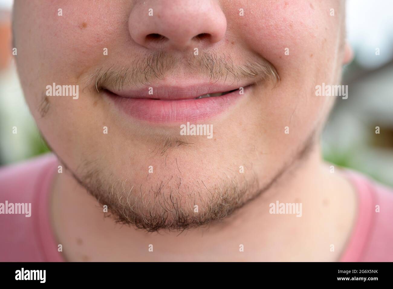 Man with wispy goatee beard and moustache posing with a quiet smile in ...