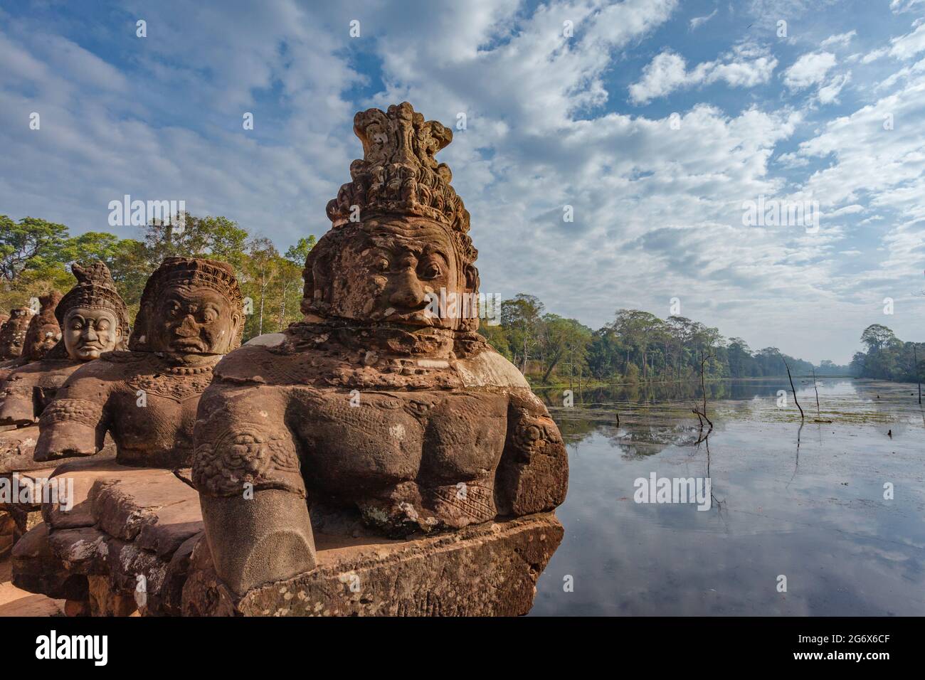 South gate of Angkor Thom along with a bridge of statues of gods and ...