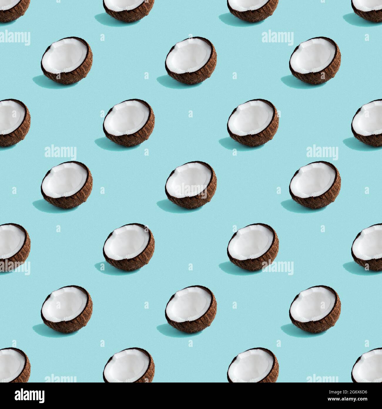 Coconut pattern on light green background. Half of coconut in minimal ...