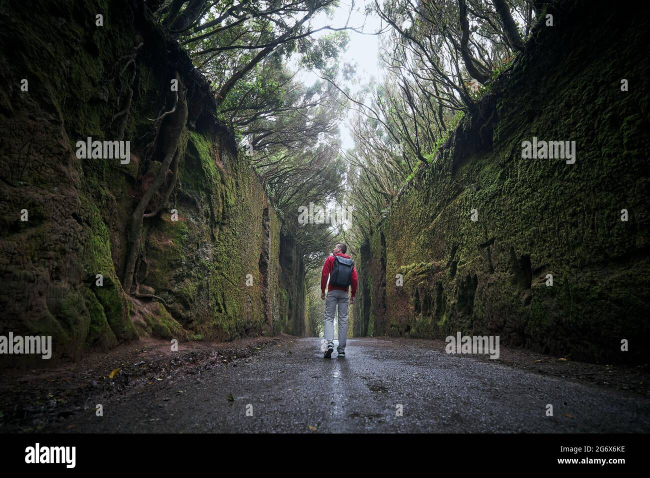 Person in between rocks hi-res stock photography and images - Alamy