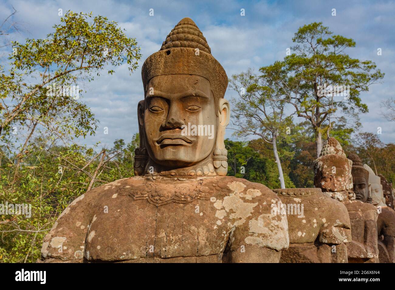 South gate of Angkor Thom along with a bridge of statues of gods and ...