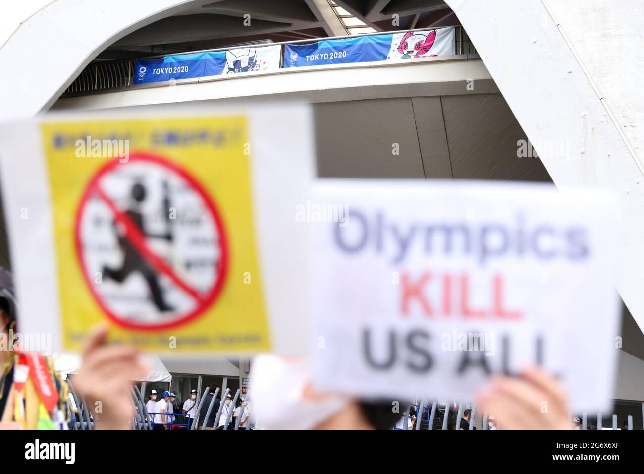 JULY 9, 2021 - Olympic : An anti-Olympics protester holds placards ...