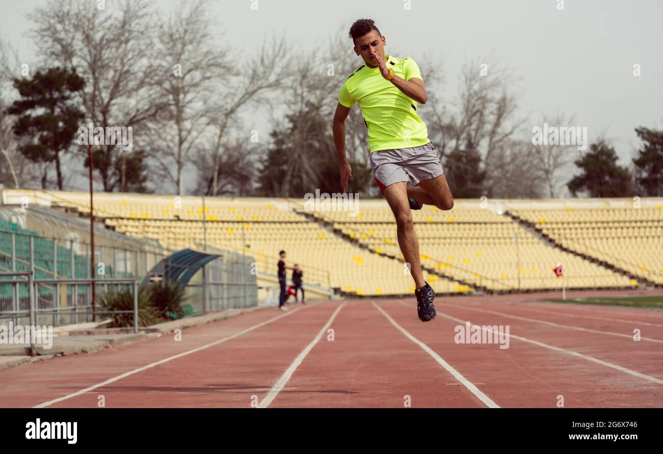 Man running in speed at sport ground Stock Photo - Alamy
