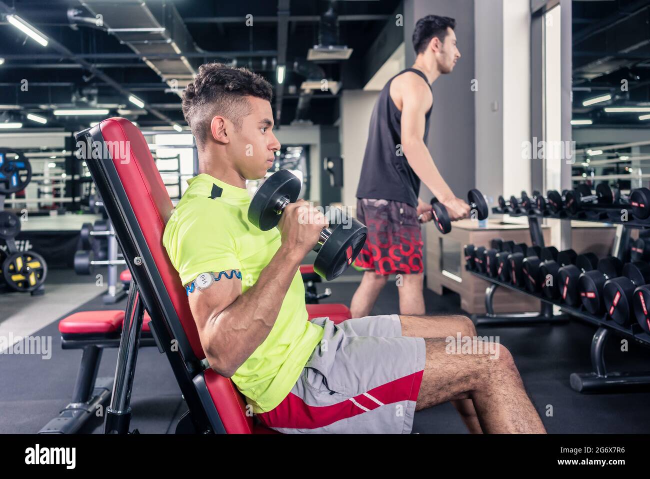 Side view of a man exercising with dumbbell Stock Photo - Alamy