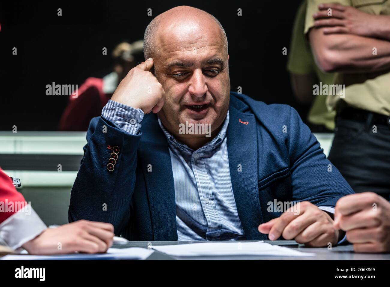 Portrait of a middle-aged man answering to the questions of the ...