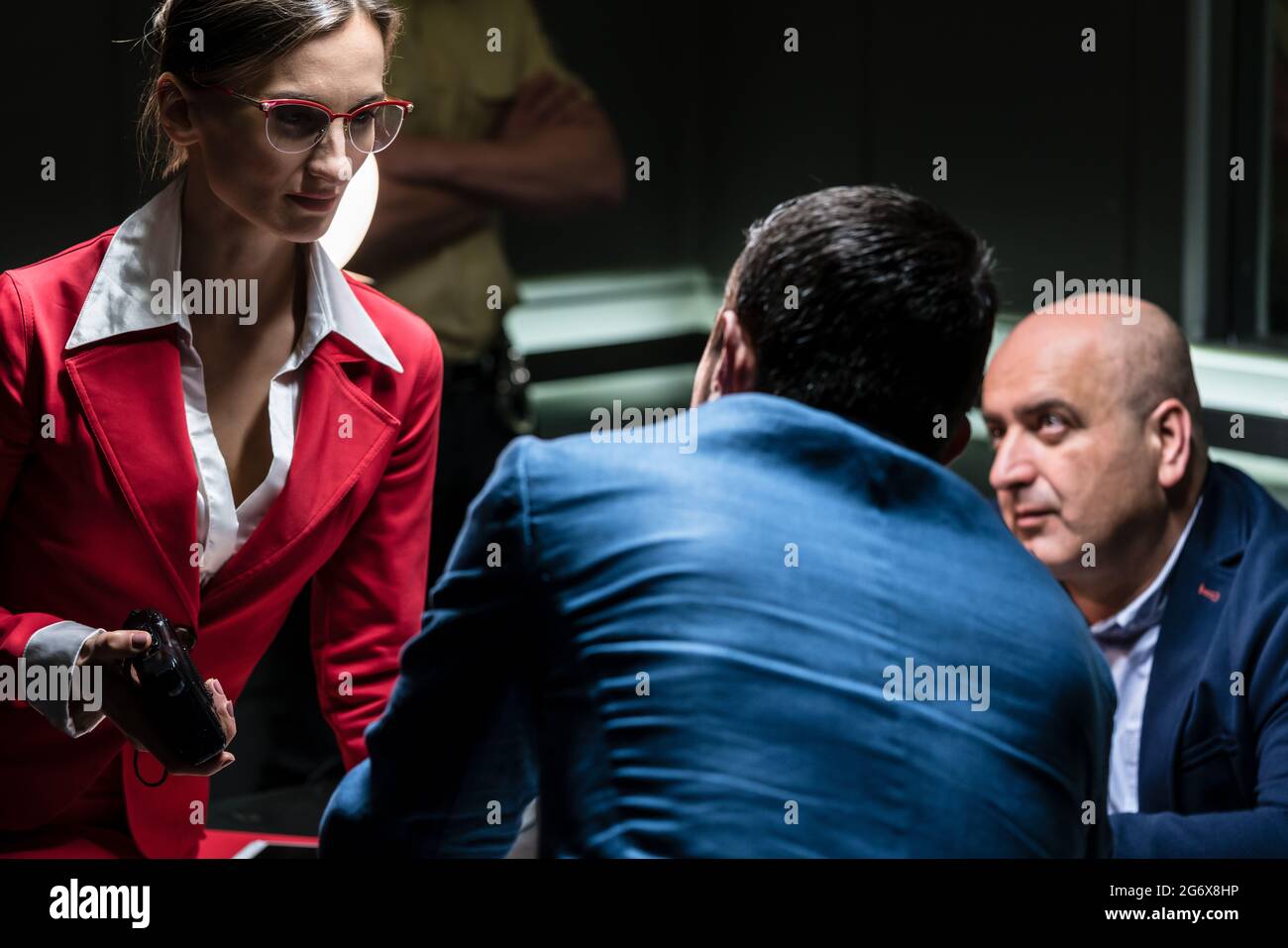 Dedicated female prosecutor holding an audio recorder while listening ...