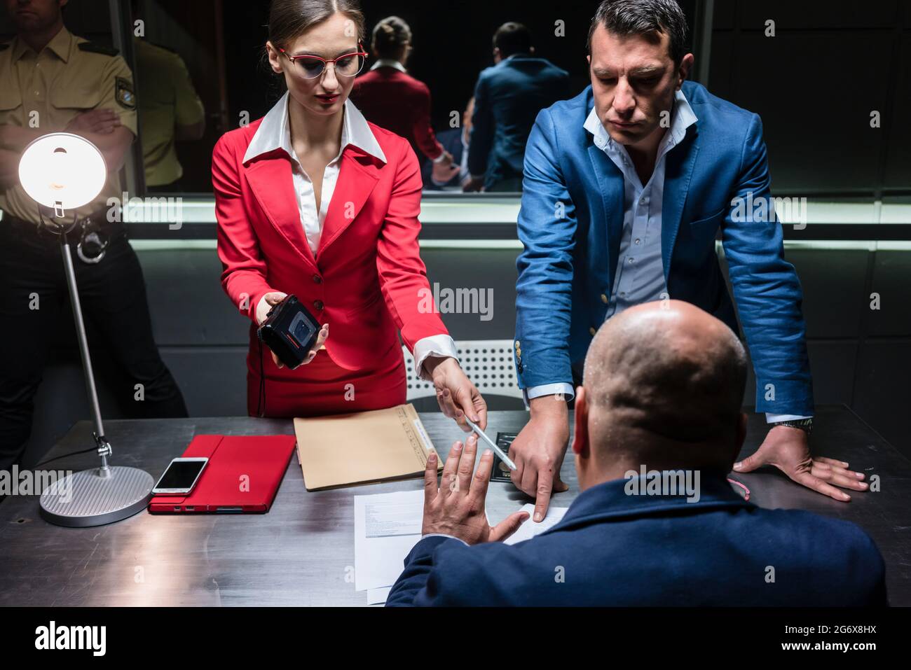 Low-angle view of two persuasive investigators trying to obtain a ...