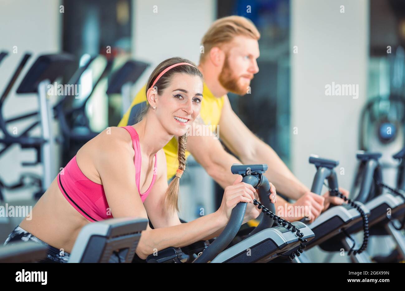 Portrait of a beautiful fit woman smiling while wearing pink fitness ...