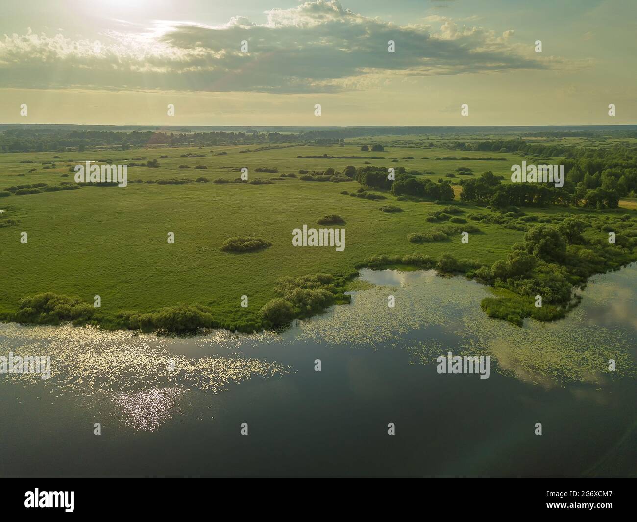 Drone view of the beautiful landscape of the lake, fields, trees on a ...
